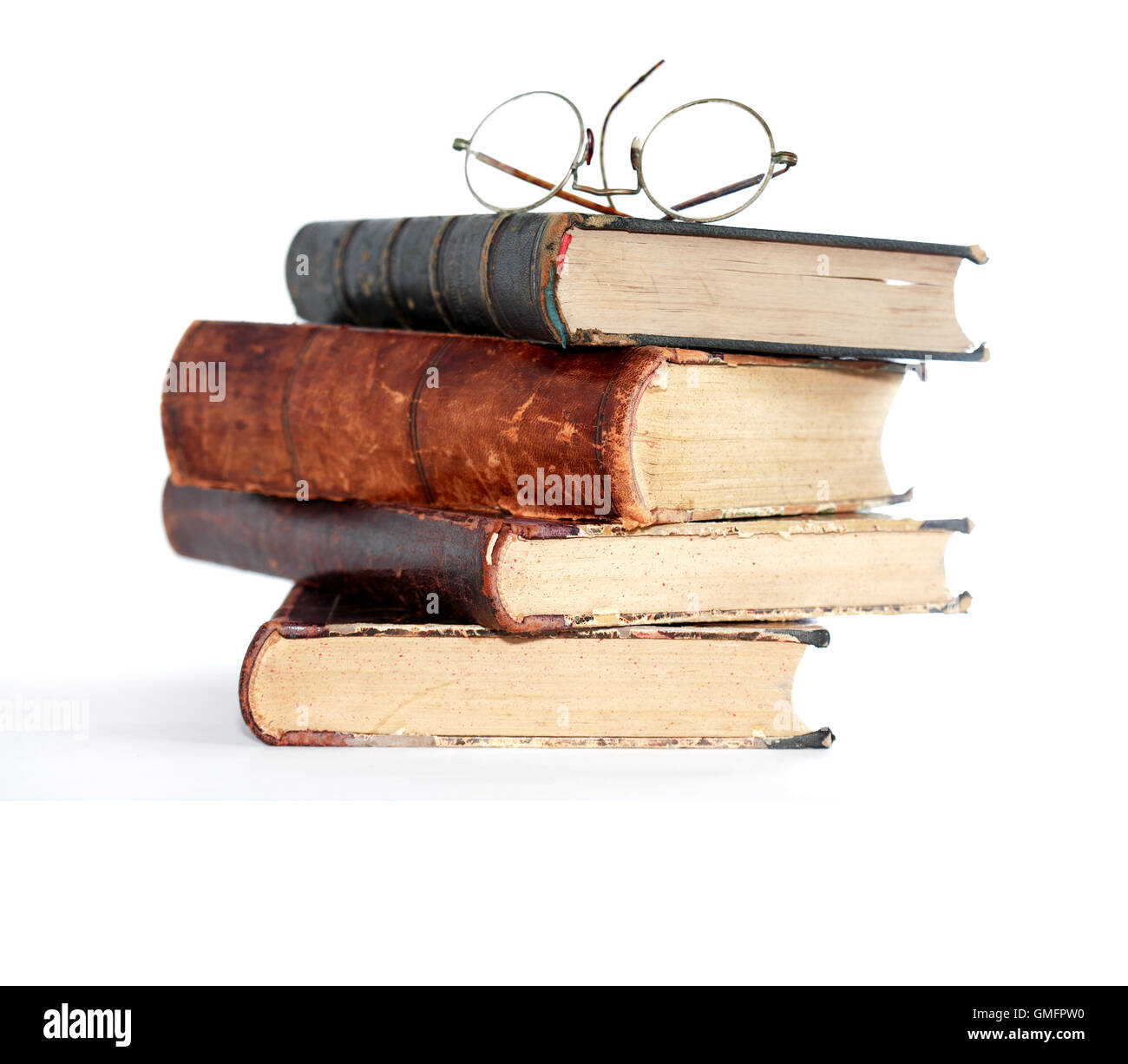 Vintage spectacles above stack of old books on white background Stock ...