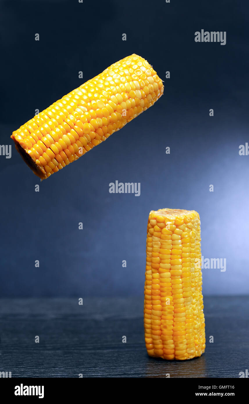 Cooking concept. Corn cob flying against nice dark background Stock ...