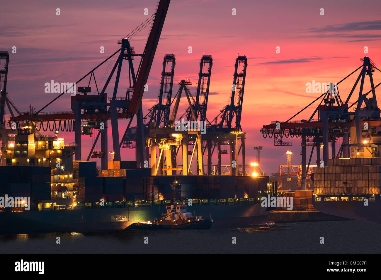 container terminal with cranes in bright evening sky Stock Photo - Alamy