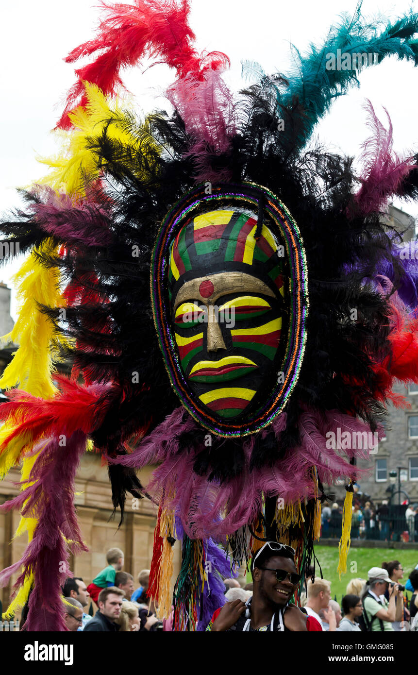 Man carrying a large feathered tribal character mask taking part in the ...