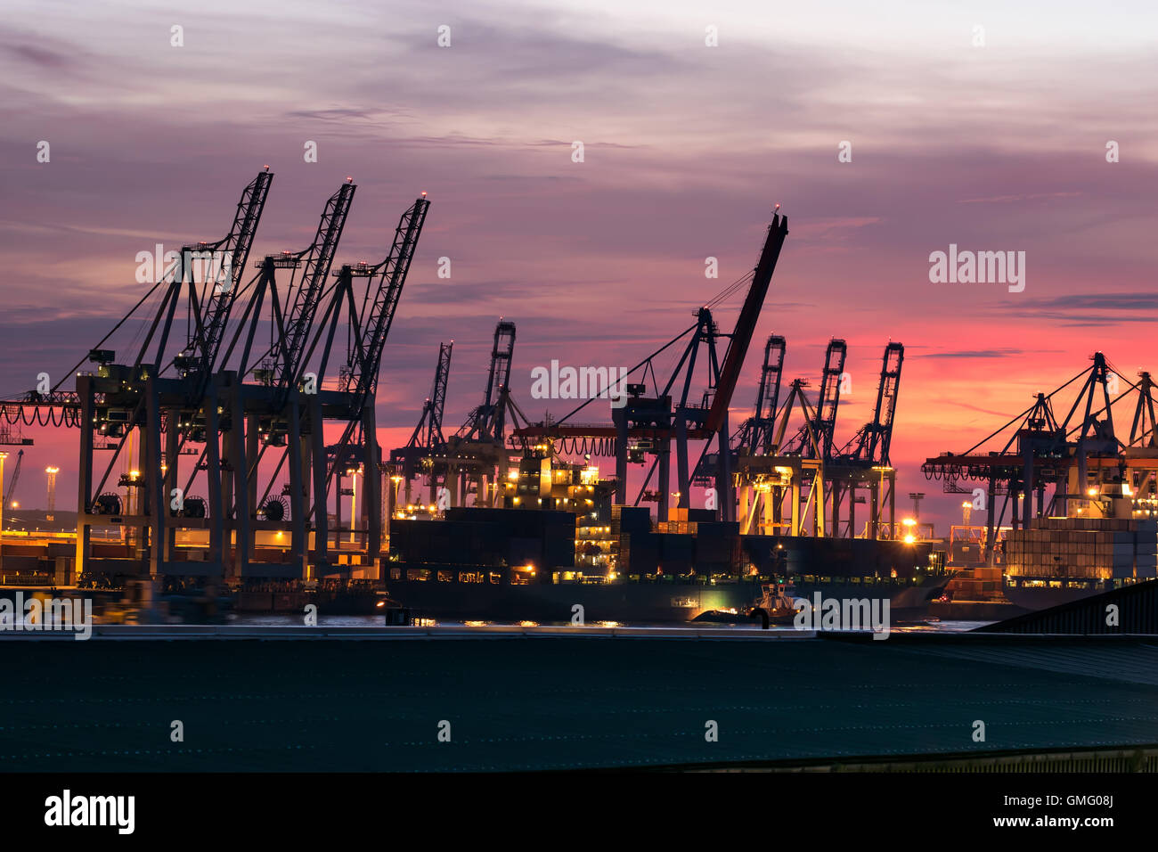 container terminal with ship in red evening sky Stock Photo - Alamy