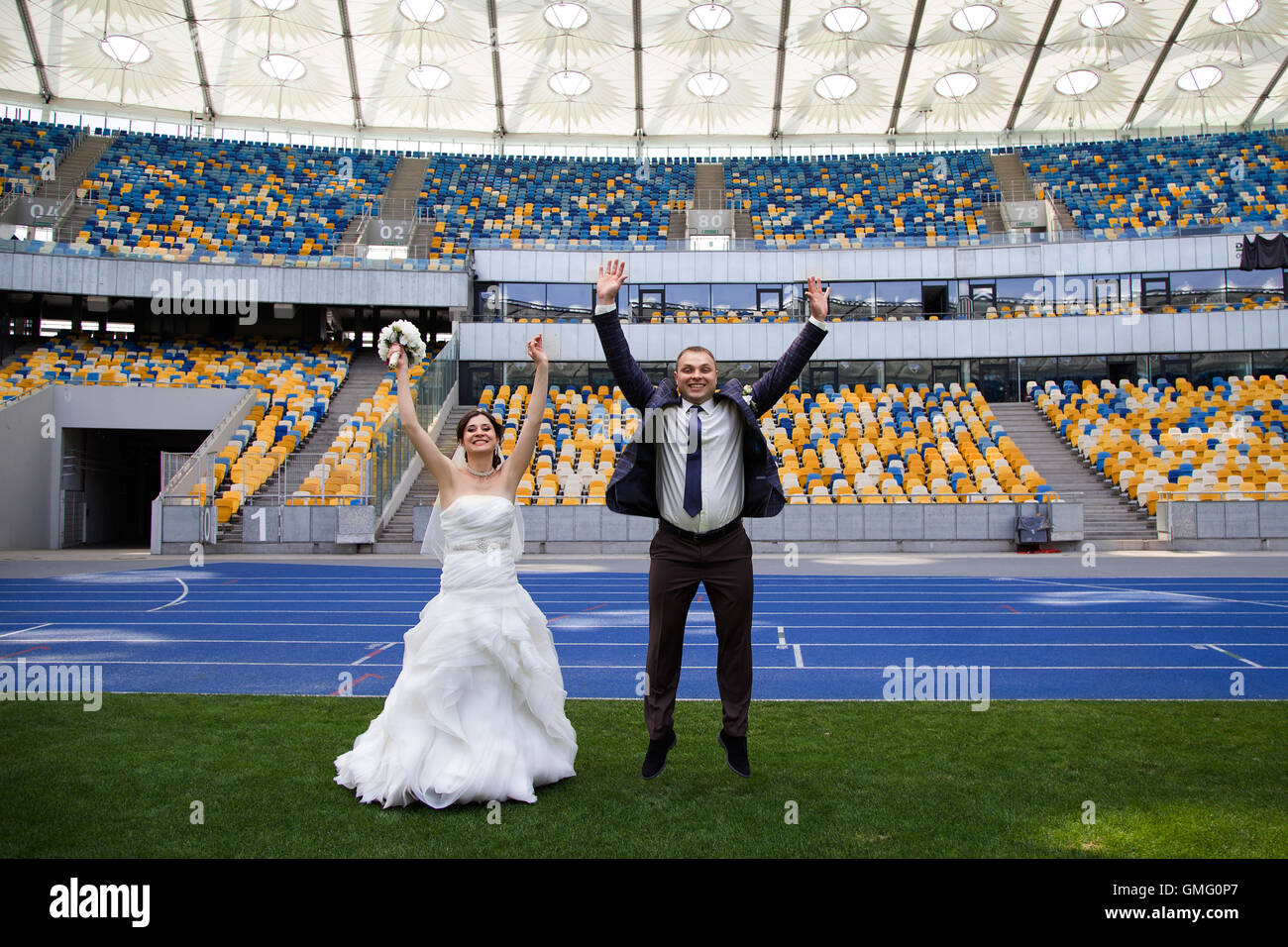 Newlyweds at the stadium Stock Photo - Alamy