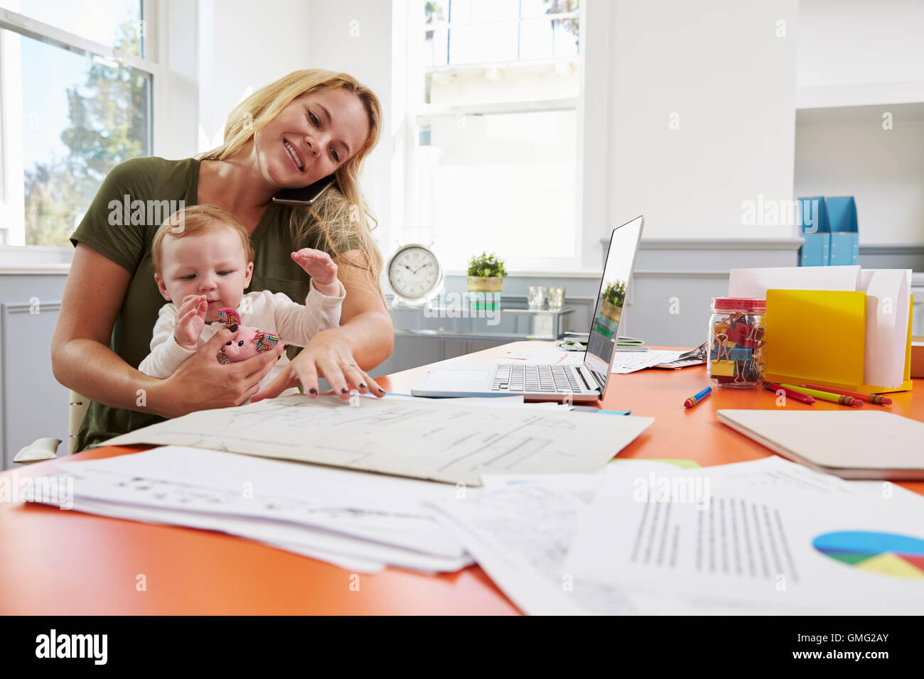 Busy Mother With Baby Running Business From Home Stock Photo - Alamy