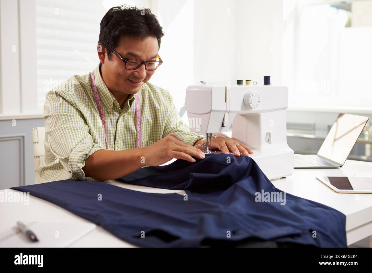 Man Making Clothes Using Sewing Machine At Home Stock Photo - Alamy
