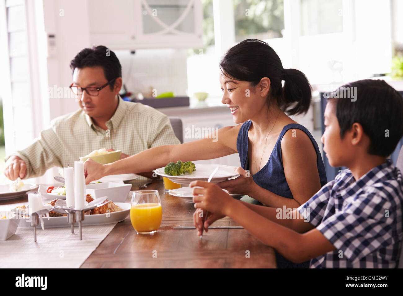 Family Eating Meal At Home Together Stock Photo - Alamy