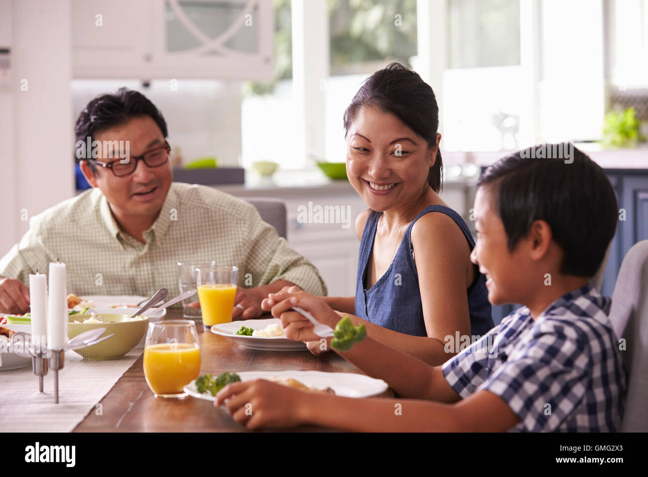Family Eating Meal At Home Together Stock Photo - Alamy