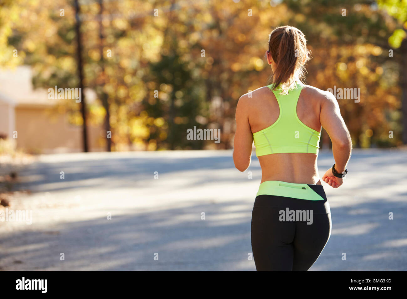 Caucasian woman jogging on country road hi-res stock photography and ...