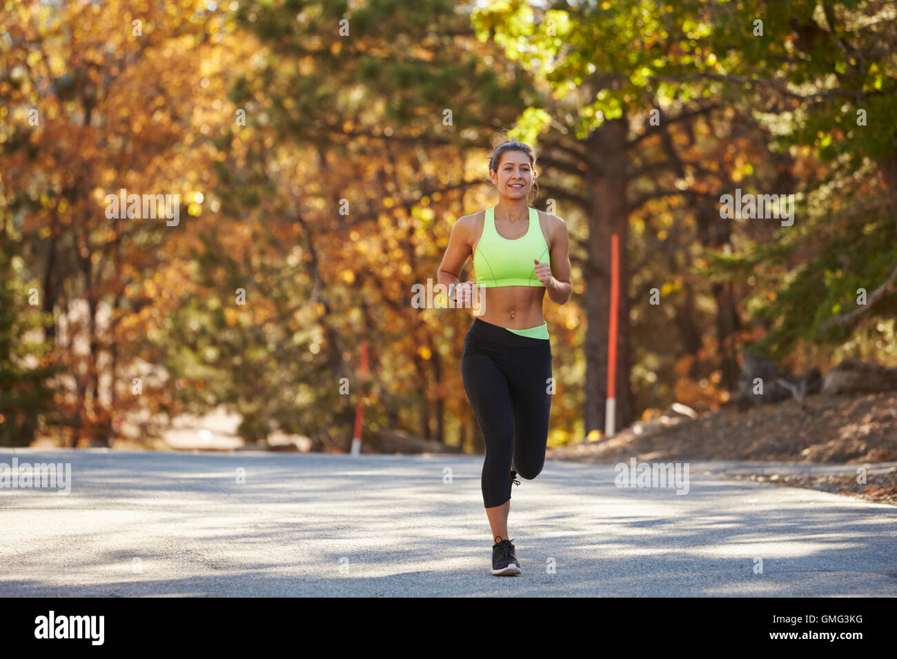 Woman jogging on country road hi-res stock photography and images - Alamy