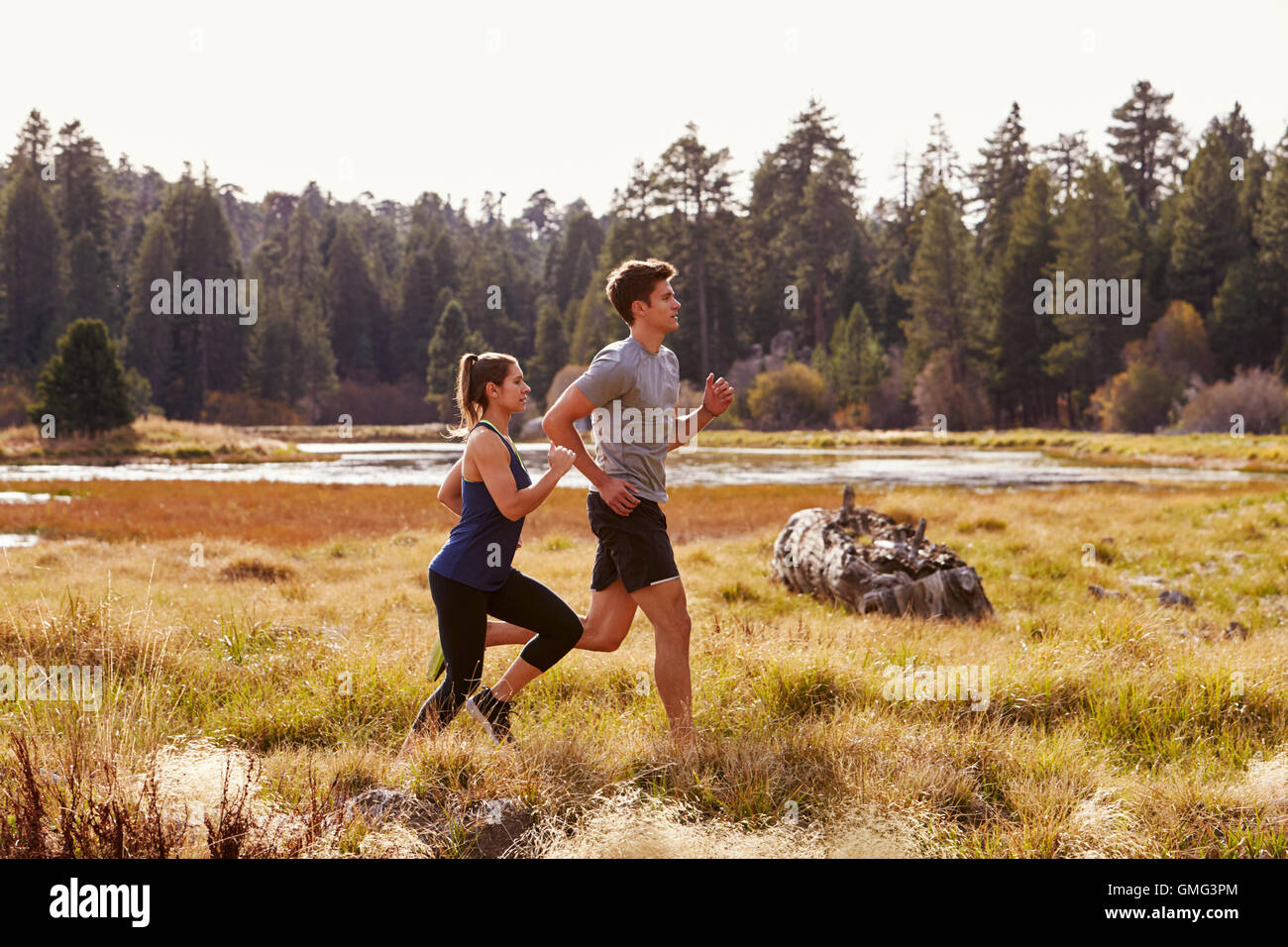 Woman jogging near lake hi-res stock photography and images - Alamy