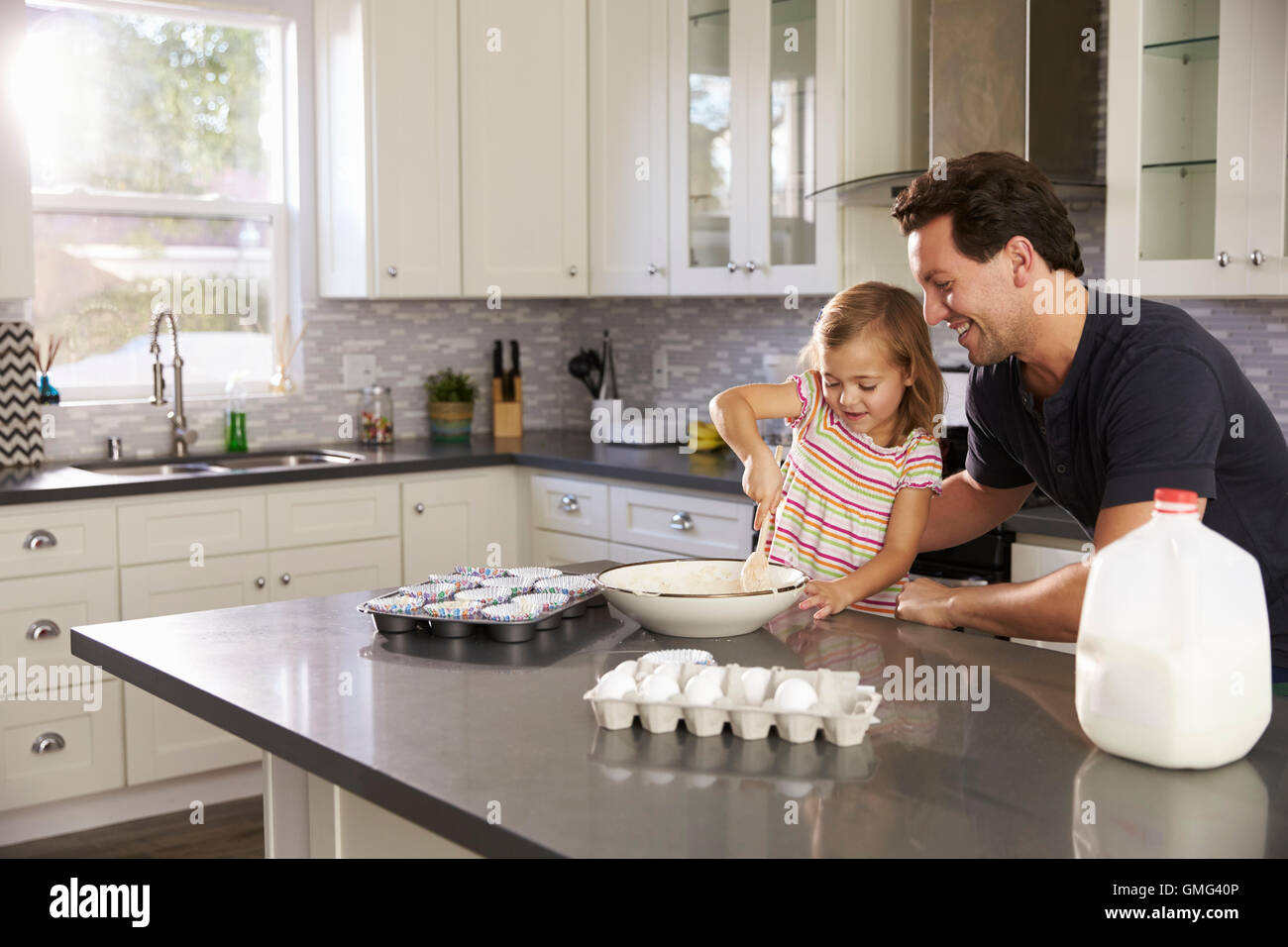 Caucasian girl and dad baking together in the kitchen Stock Photo - Alamy