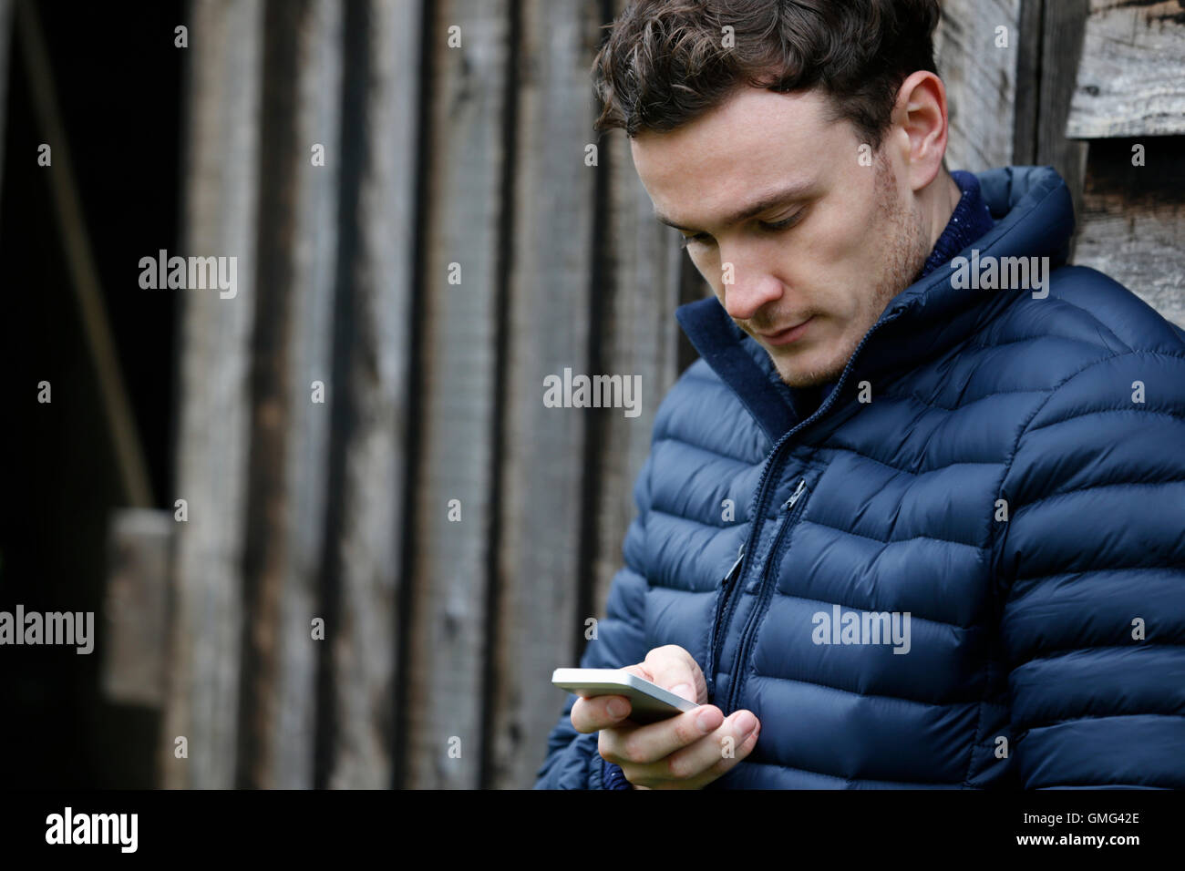 Man Outdoors Checking Mobile Phone Stock Photo - Alamy