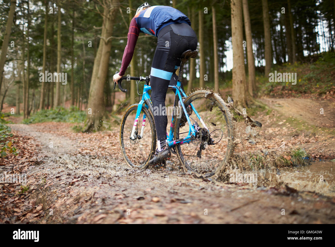 Cross country cyclist riding in mud hi-res stock photography and images ...