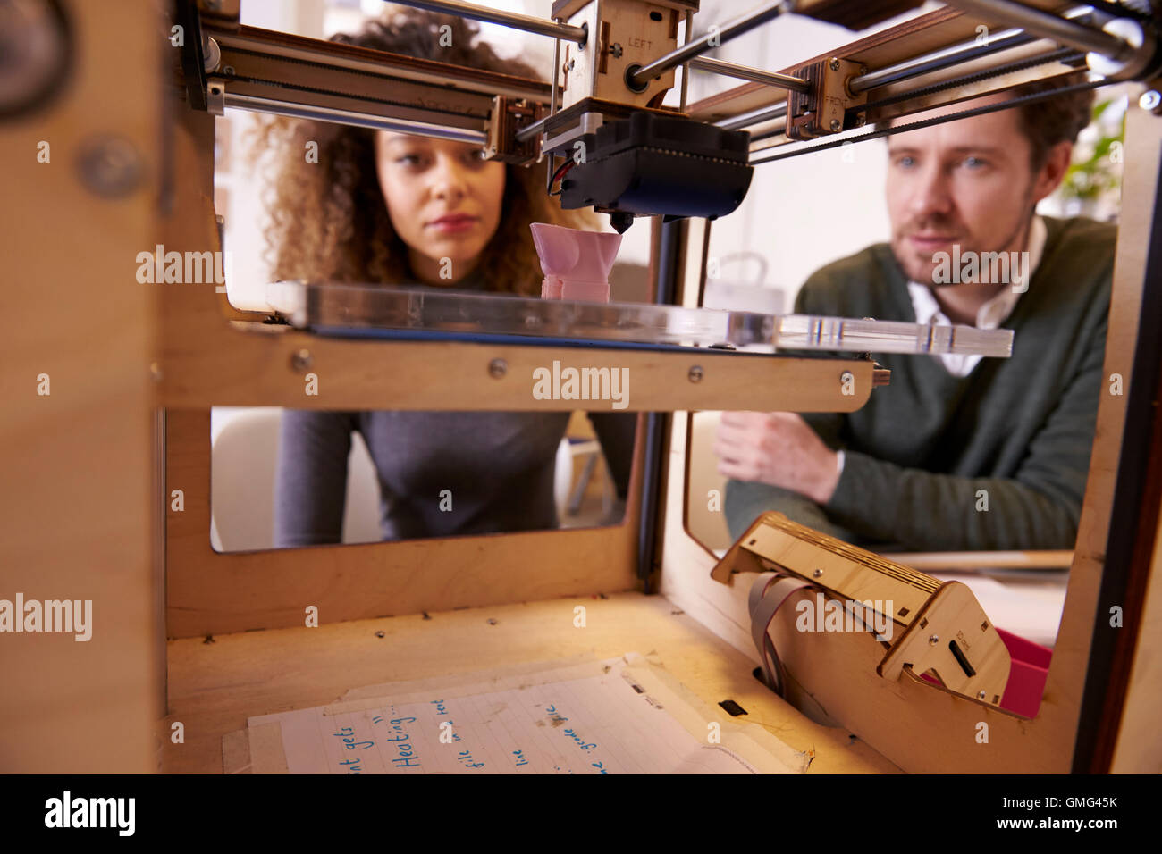 Two Designers Working With 3D Printer In Design Studio Stock Photo - Alamy