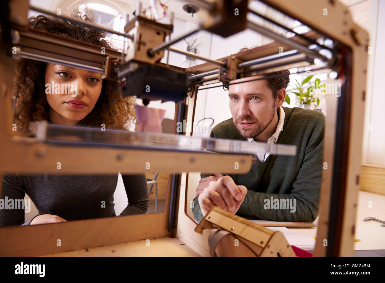 Two Designers Working With 3D Printer In Design Studio Stock Photo - Alamy