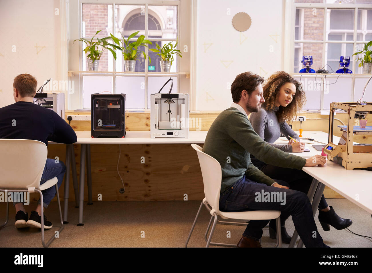 Team Of Designers Working With 3D Printer In Design Studio Stock Photo ...
