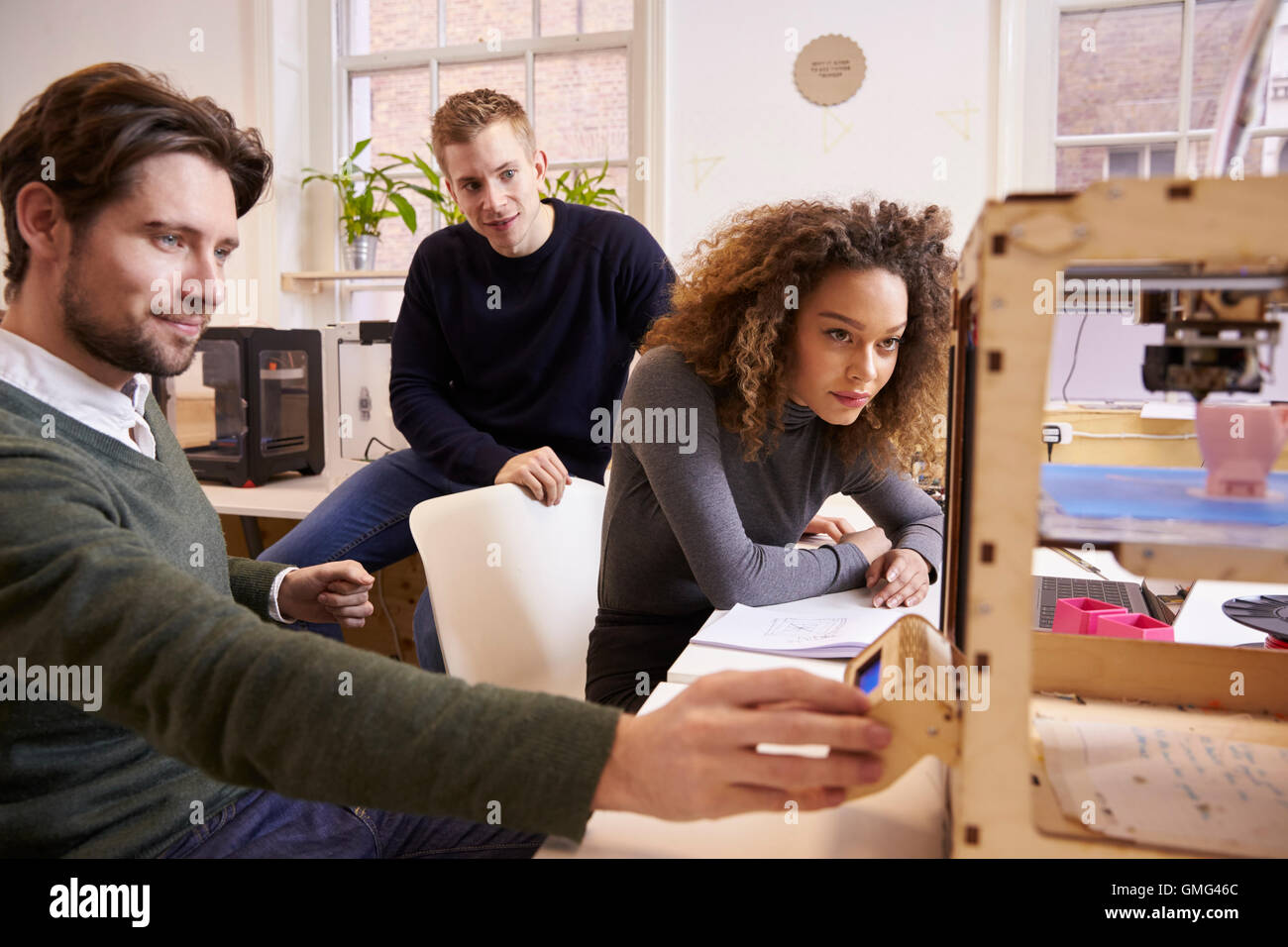 Team Of Designers Working With 3D Printer In Design Studio Stock Photo ...