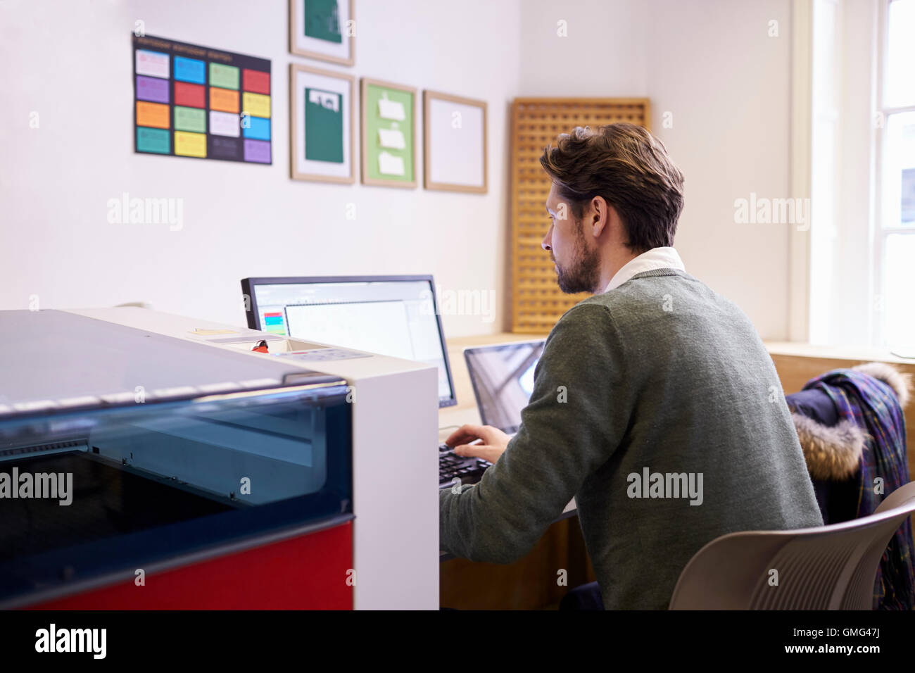 Male Designer Operating CAD System For Laser Cutter Stock Photo - Alamy