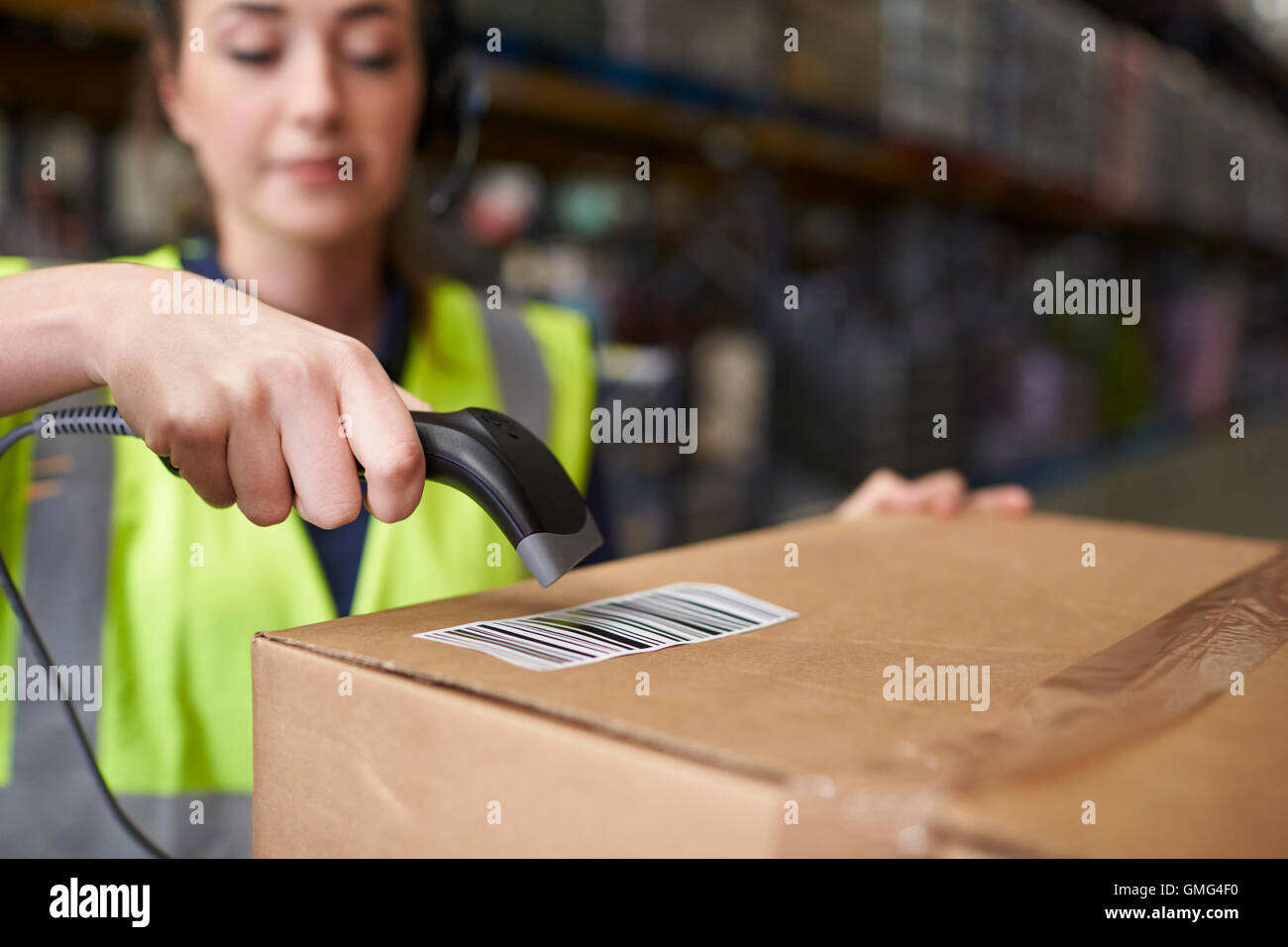 Woman using barcode reader on a box in a warehouse, detail Stock Photo ...