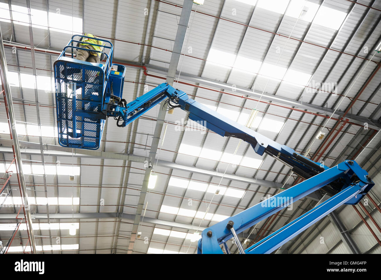 Low angle view of a cherry picker being used in a warehouse Stock Photo ...