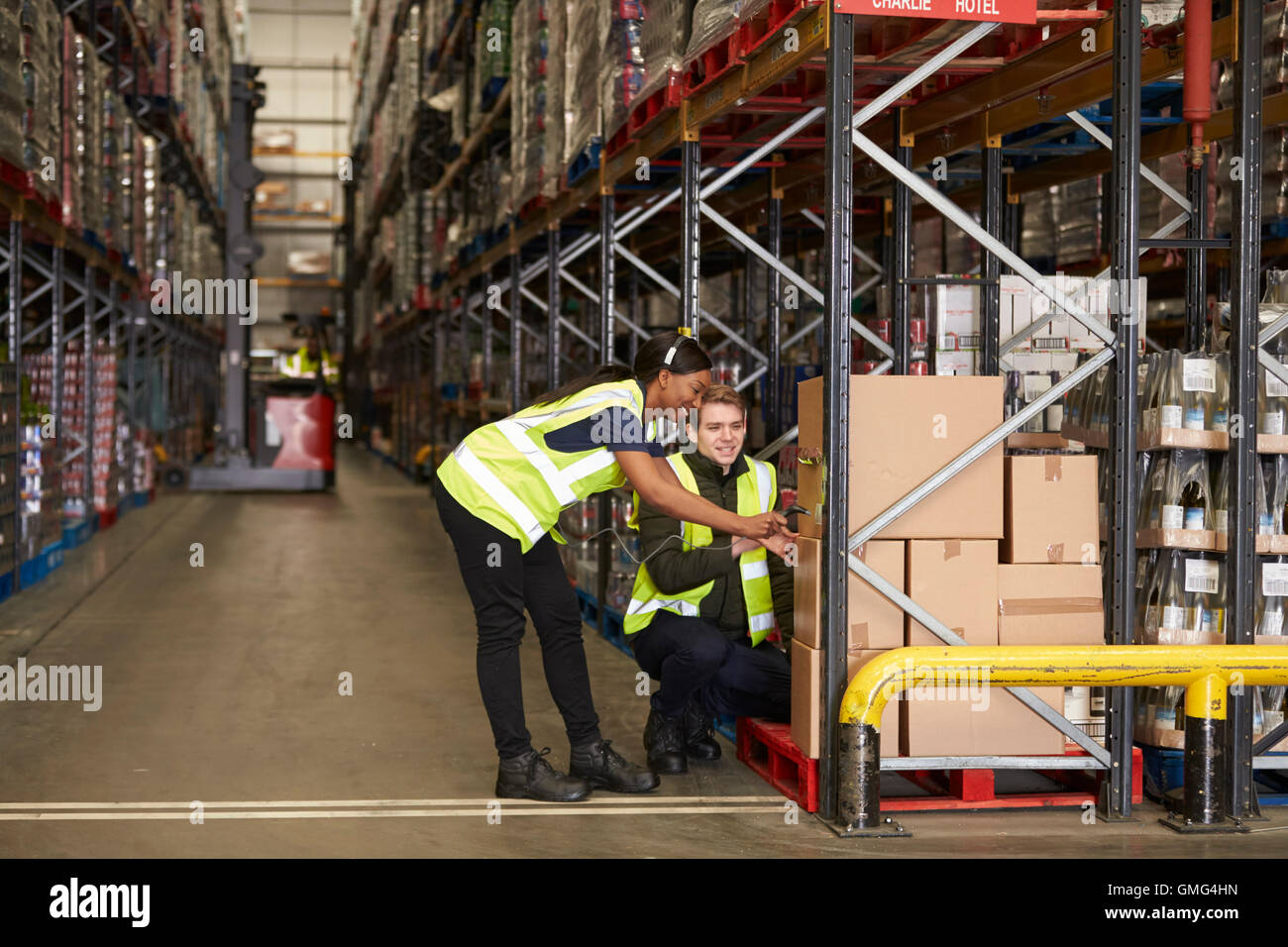 Staff identifying boxes in a distribution warehouse Stock Photo - Alamy