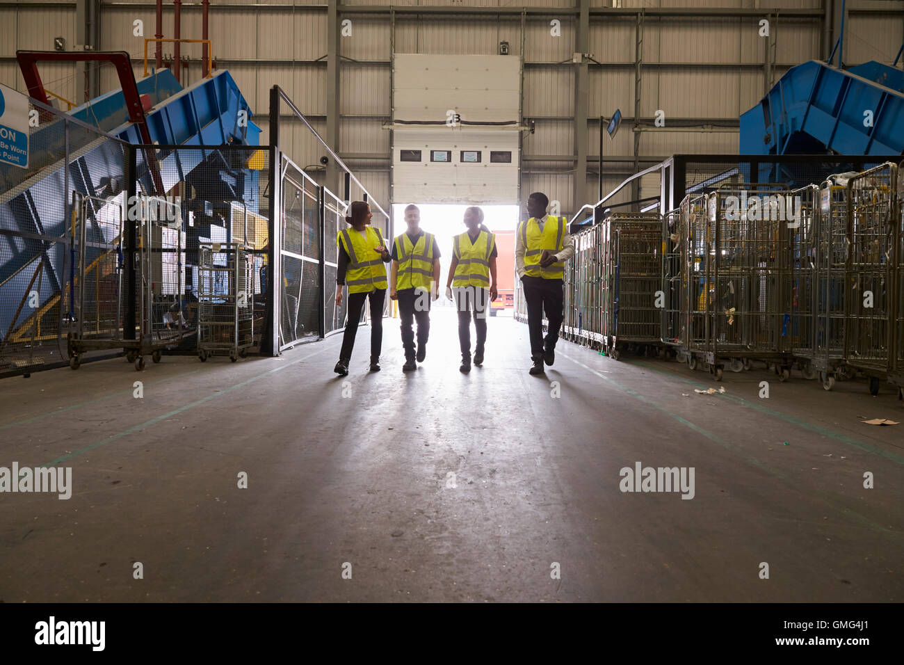 Four colleagues walking into a warehouse hi-res stock photography and ...