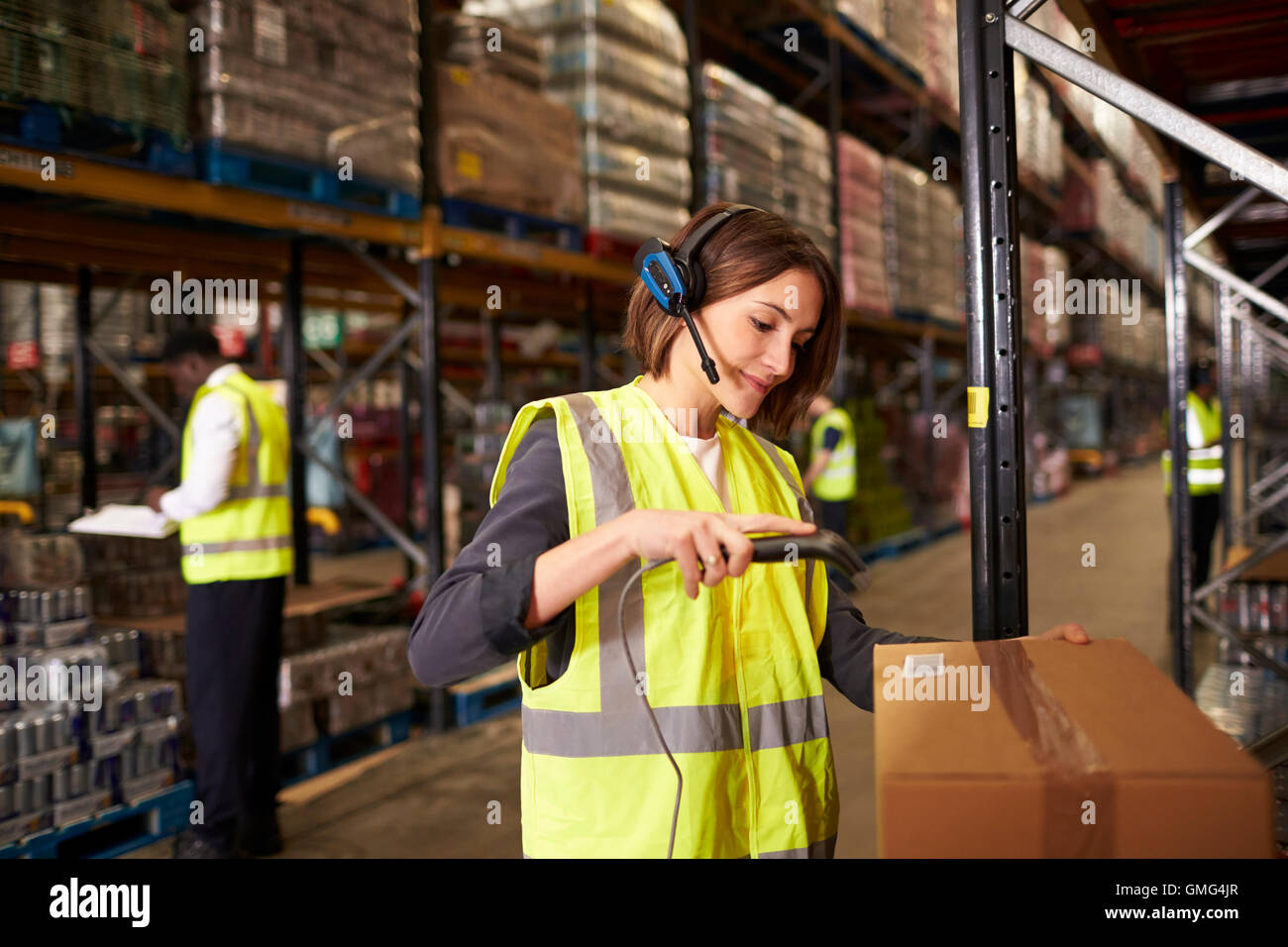 Woman using a barcode reader in a distribution warehouse Stock Photo ...