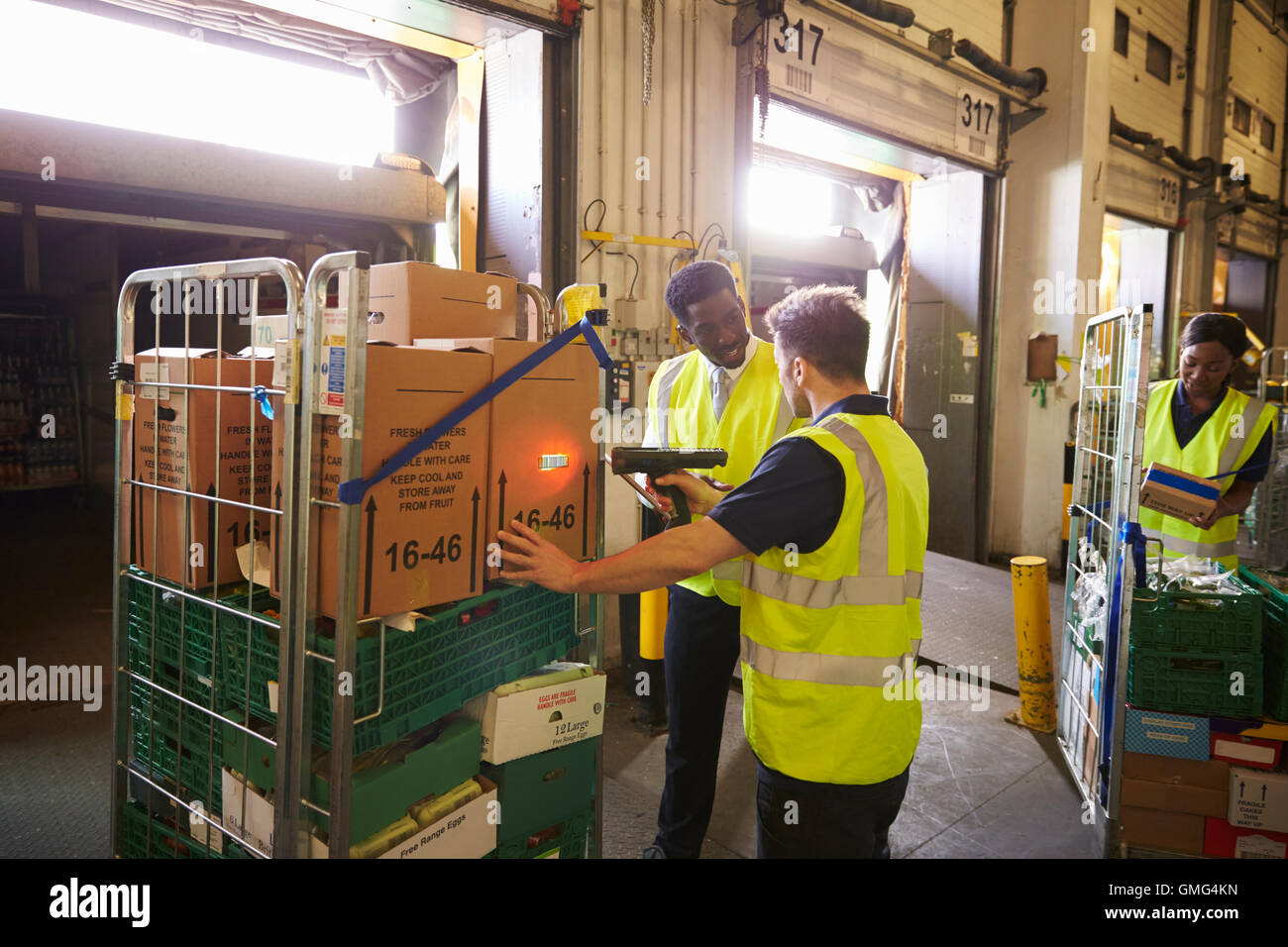 Warehouse manager overseeing the preparation of a delivery Stock Photo ...