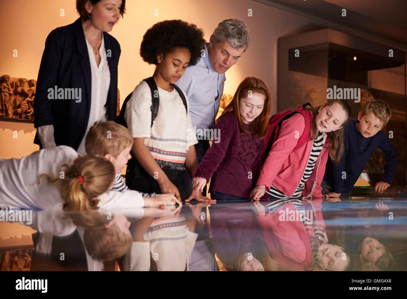 Pupils On School Field Trip To Museum Looking At Map Stock Photo - Alamy