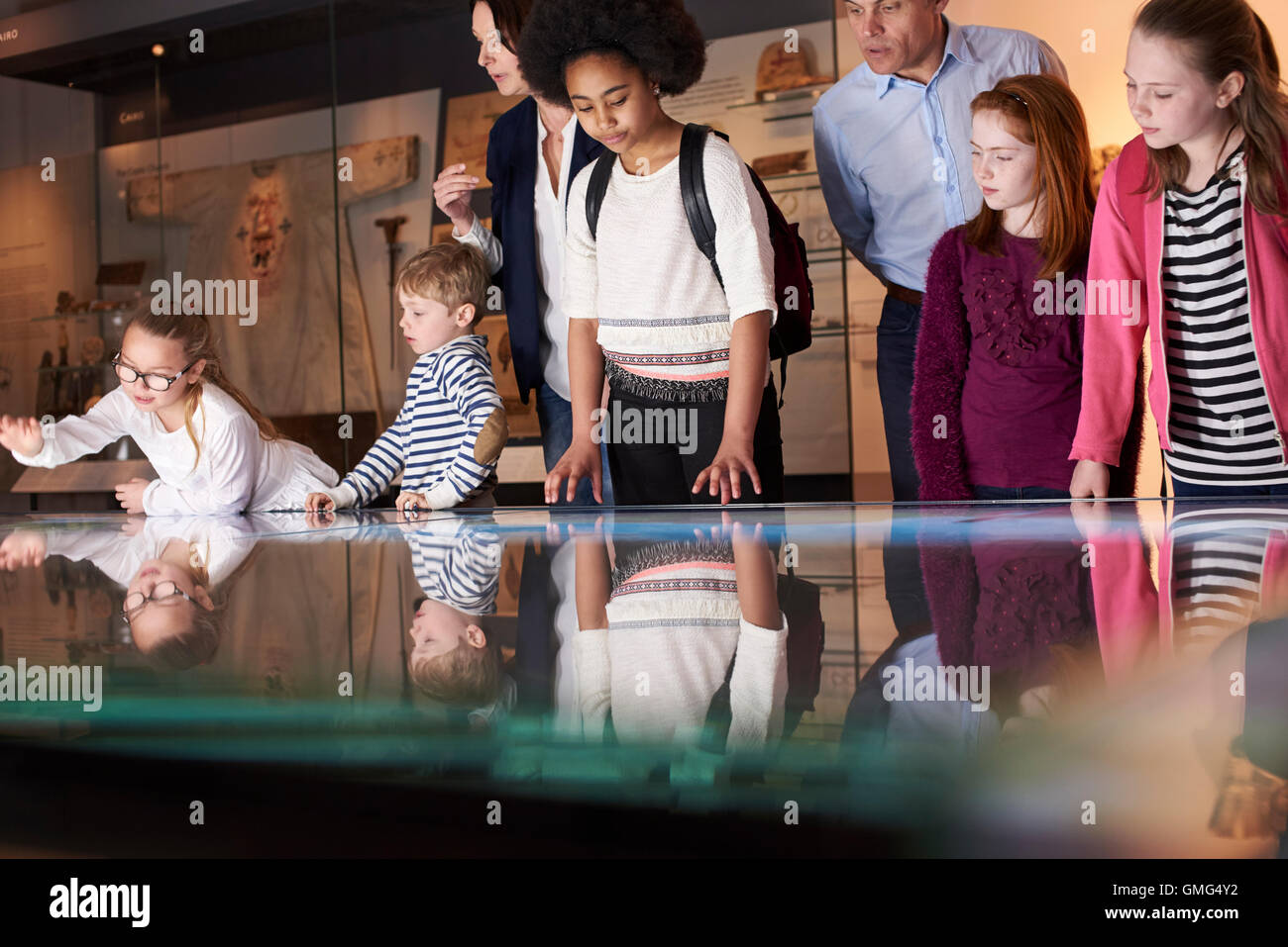 Pupils On School Field Trip To Museum Looking At Map Stock Photo - Alamy