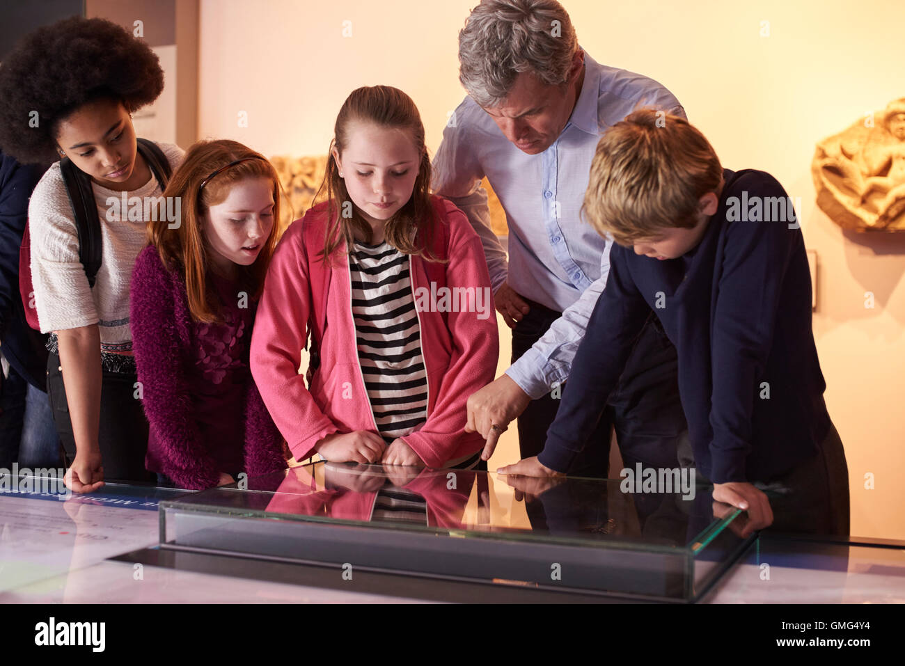 Pupils On School Field Trip To Museum Looking At Map Stock Photo - Alamy