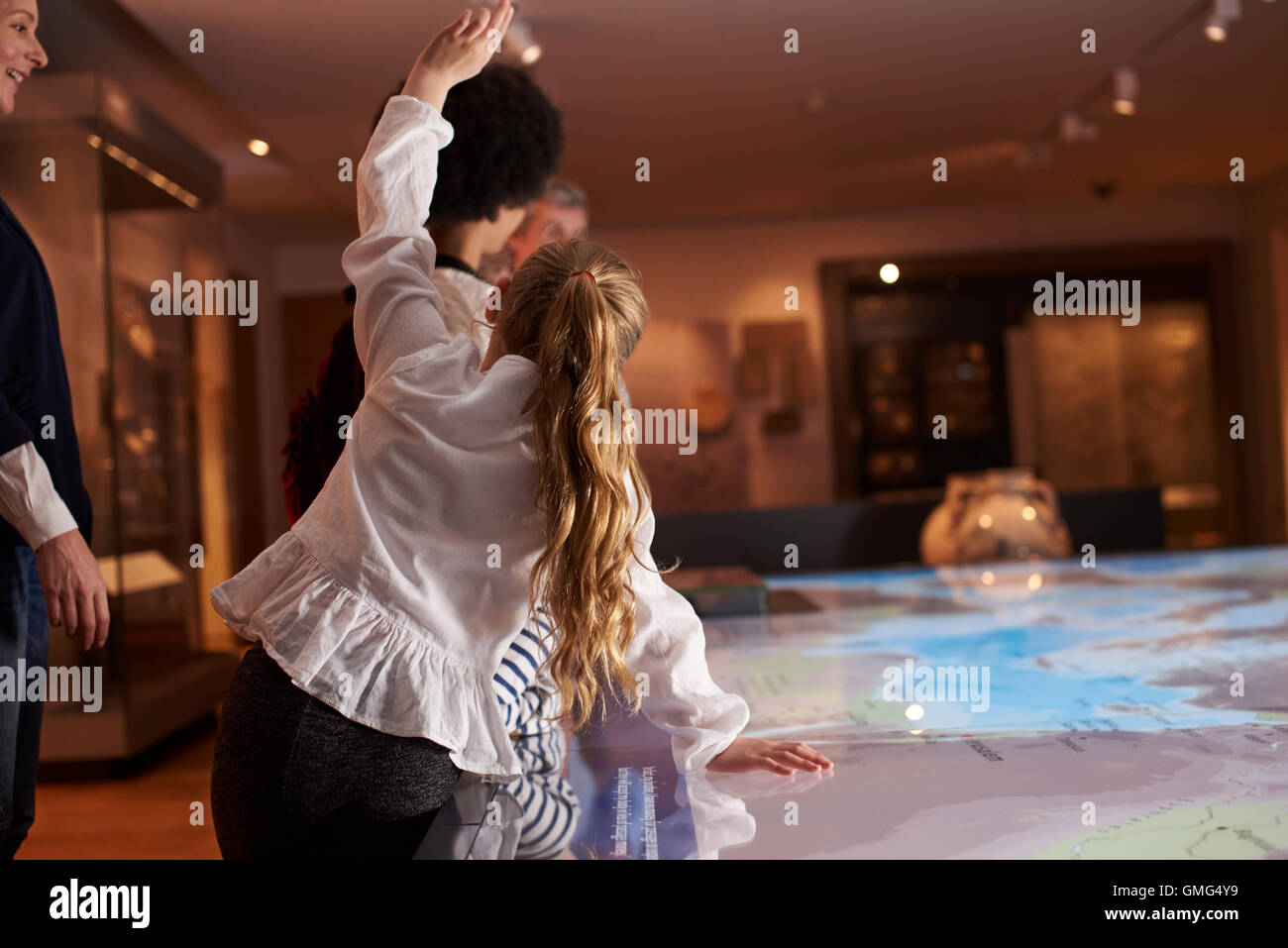 Pupils On School Field Trip To Museum Looking At Map Stock Photo - Alamy