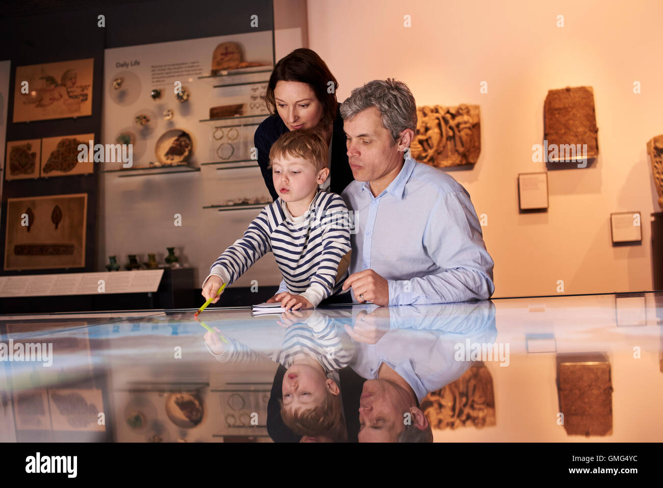 Family On Trip To Museum Looking At Map Together Stock Photo - Alamy