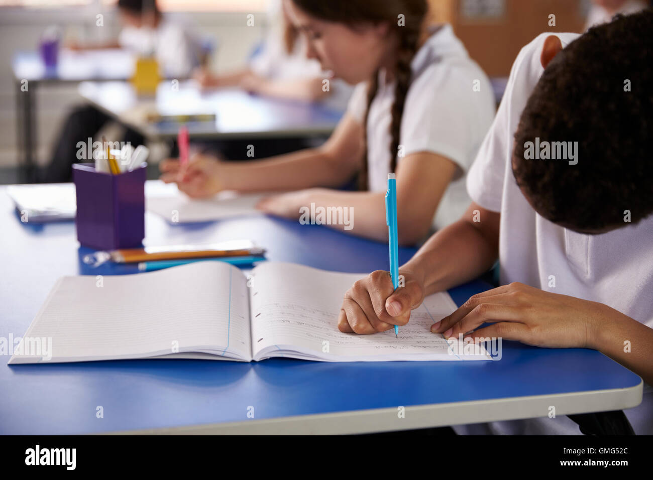 Primary school kids writing at heir desks hi-res stock photography and ...