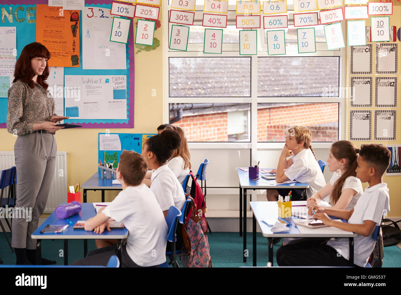 Teacher using tablet computer during a primary school class Stock Photo ...