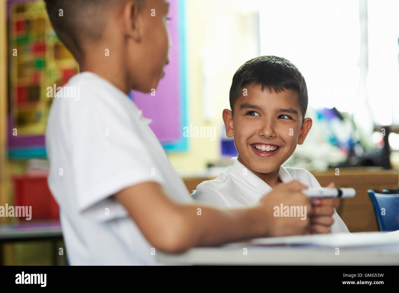 Close up of two primary school boys interacting in class Stock Photo ...
