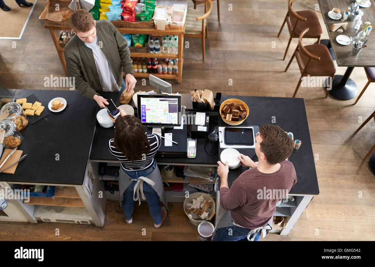 High angle view of man paying over counter at a coffee shop Stock Photo ...