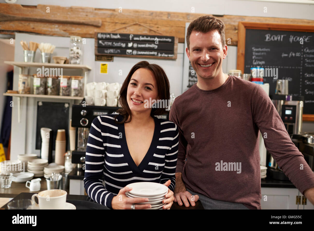 Portrait of business owners working behind counter at cafe Stock Photo ...