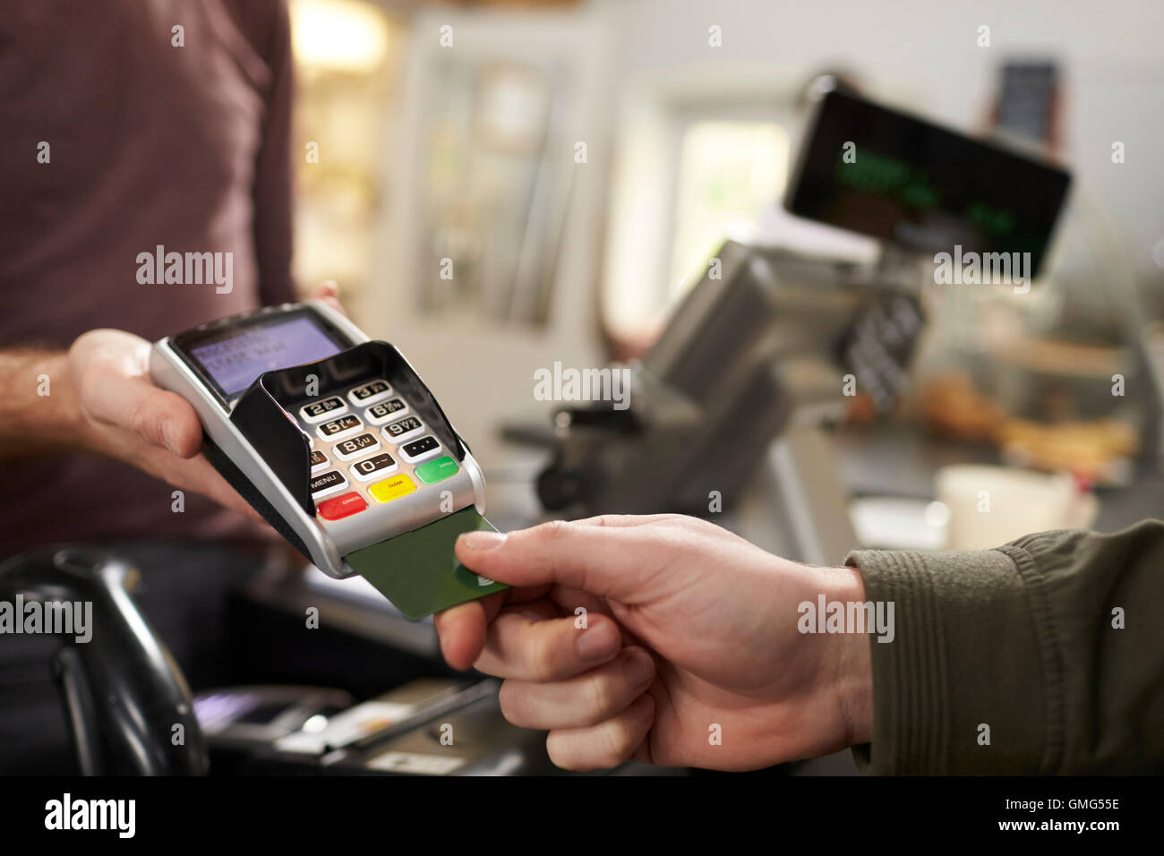 Customer makes credit card payment over counter at a cafe Stock Photo ...