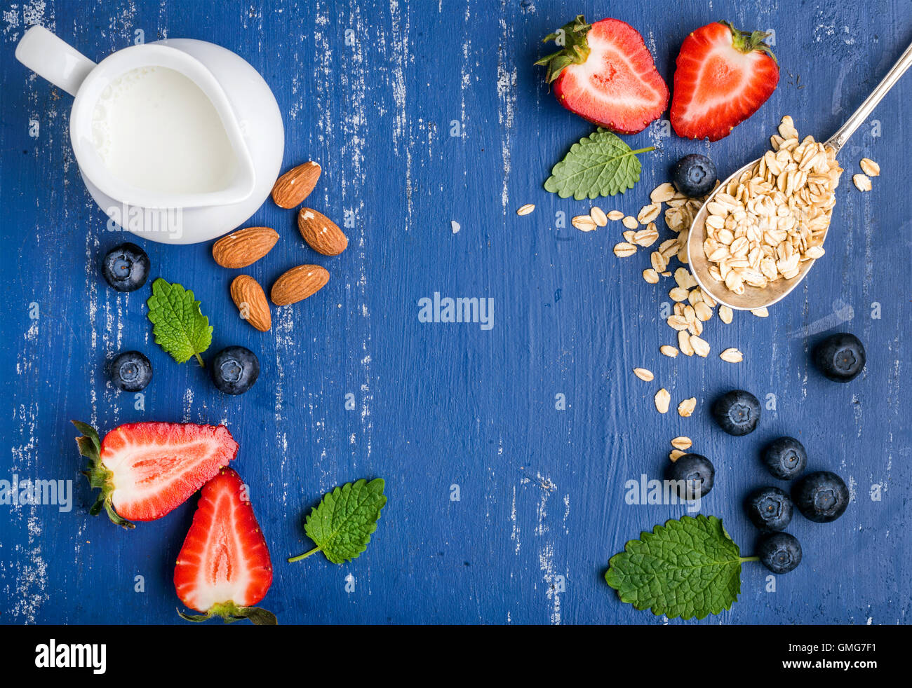 Healthy breakfast ingredients food frame. Oatmeal, milk in creamer ...