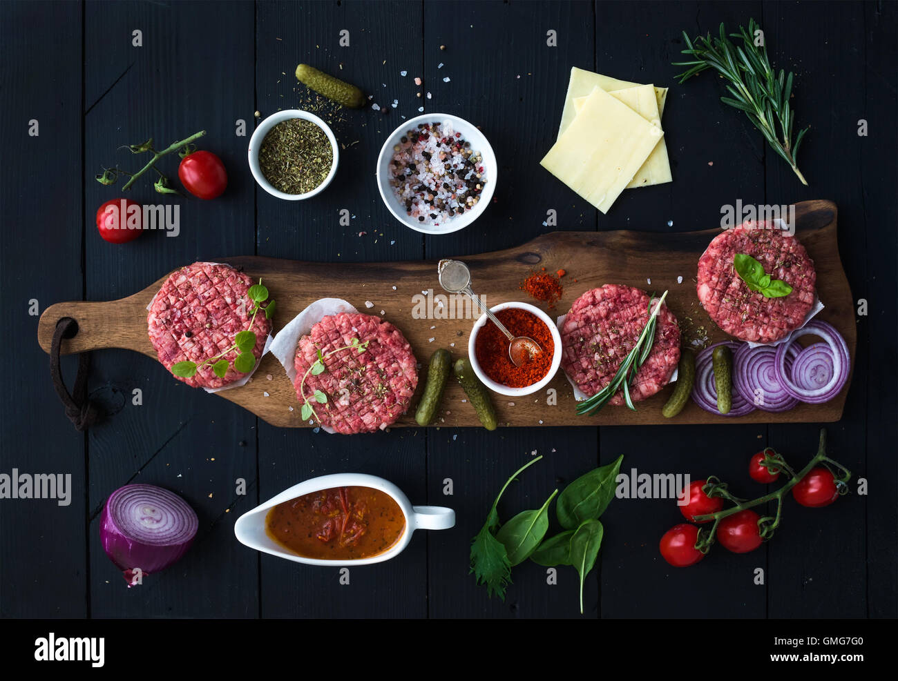 Ingredients for cooking burgers. Raw ground beef meat cutlets on wooden ...
