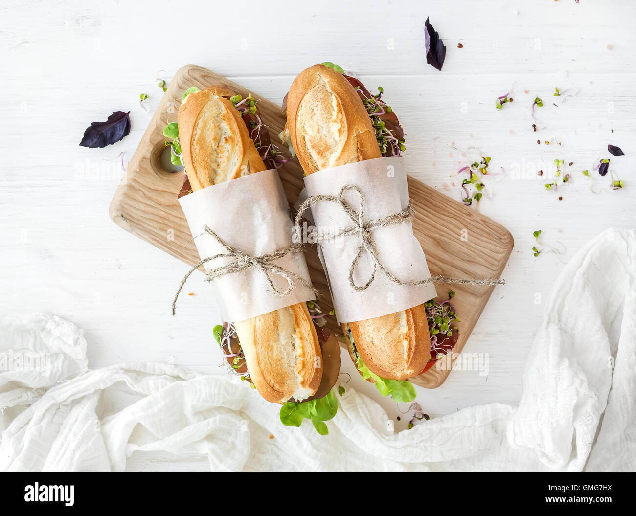 Sandwiches with beef, fresh vegetables and herbs on rustic wooden chopping board Stock Photo - Alamy