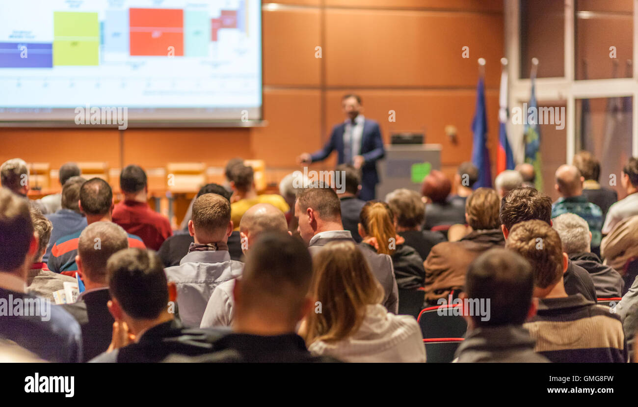 Business speaker giving a talk in conference hall Stock Photo - Alamy