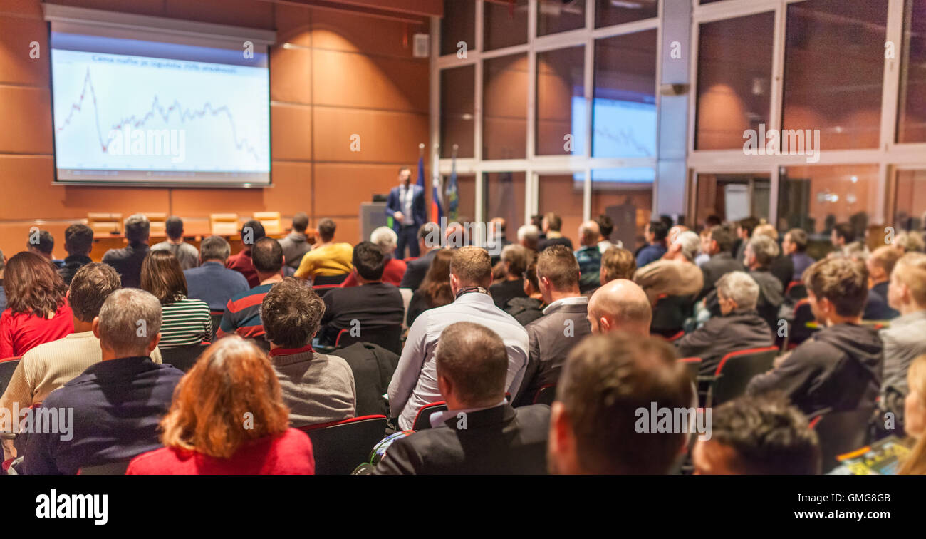 Business speaker giving a talk in conference hall Stock Photo - Alamy