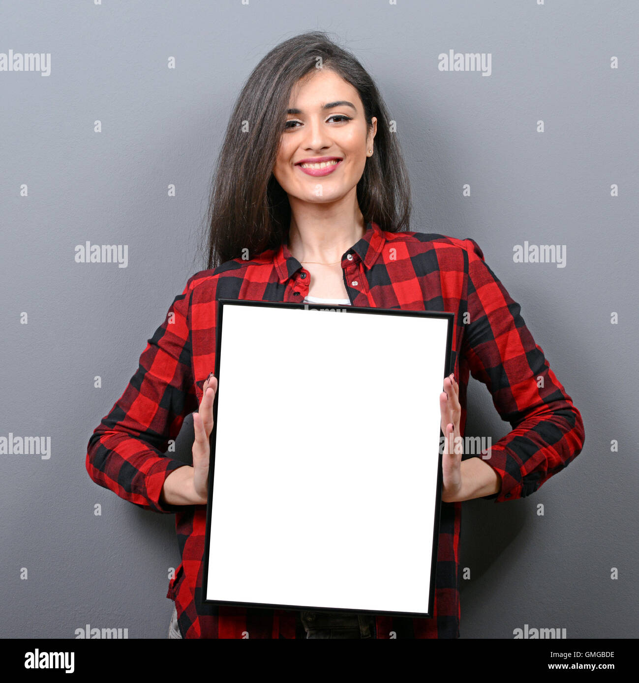 Portrait of smiling woman holding blank sign board.Studio portrait of ...