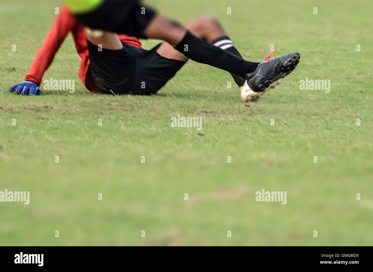 In play soccer goalkeeper laying down to defence attack Stock Photo - Alamy