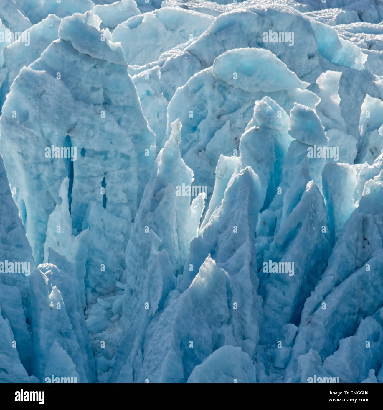 The blue of glacier ice is intensified by backlit sunshine Stock Photo ...