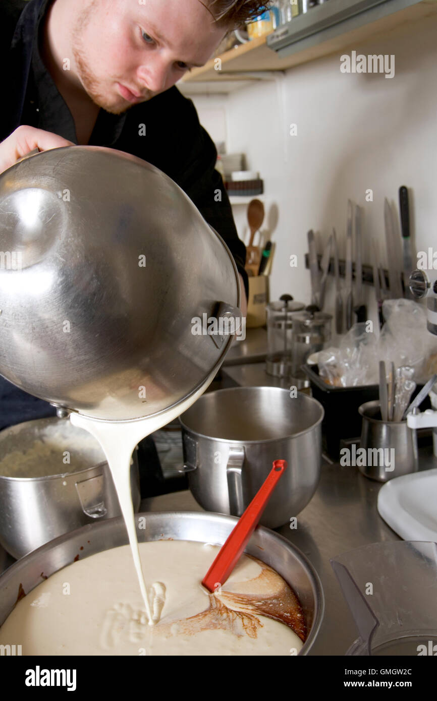 Professional chef at work in a restaurant kitchen, chocolate mousse ...
