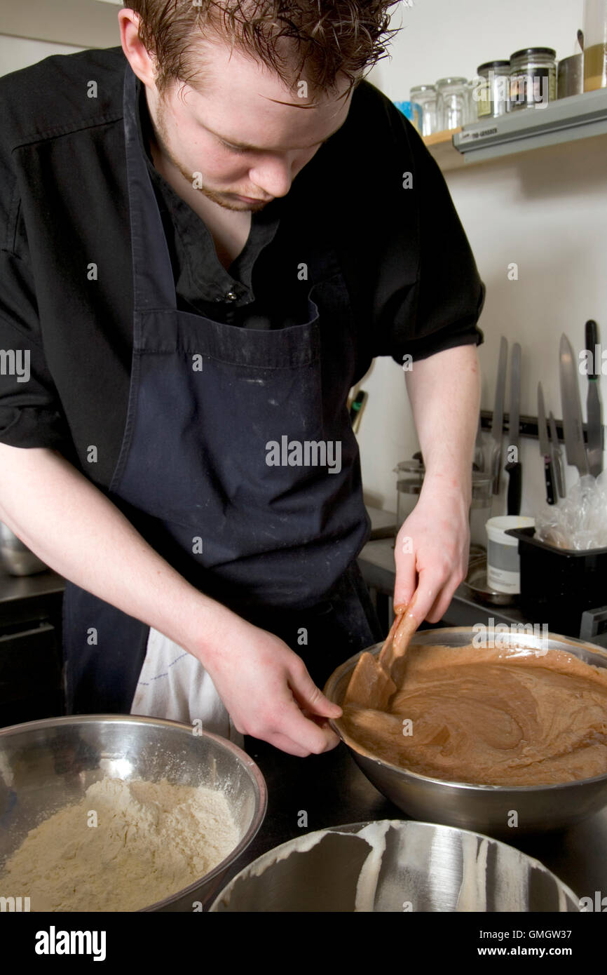 Professional chef at work in a restaurant kitchen, chocolate mousse ...