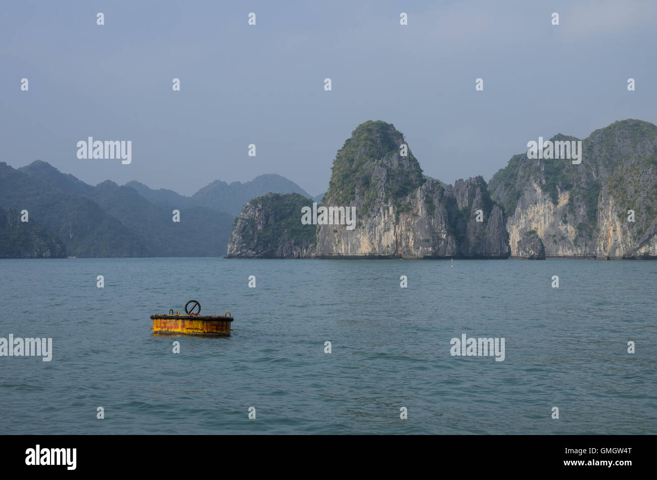 Beautiful limestone mountain scenery with yellow buoy at Ha Long Bay ...