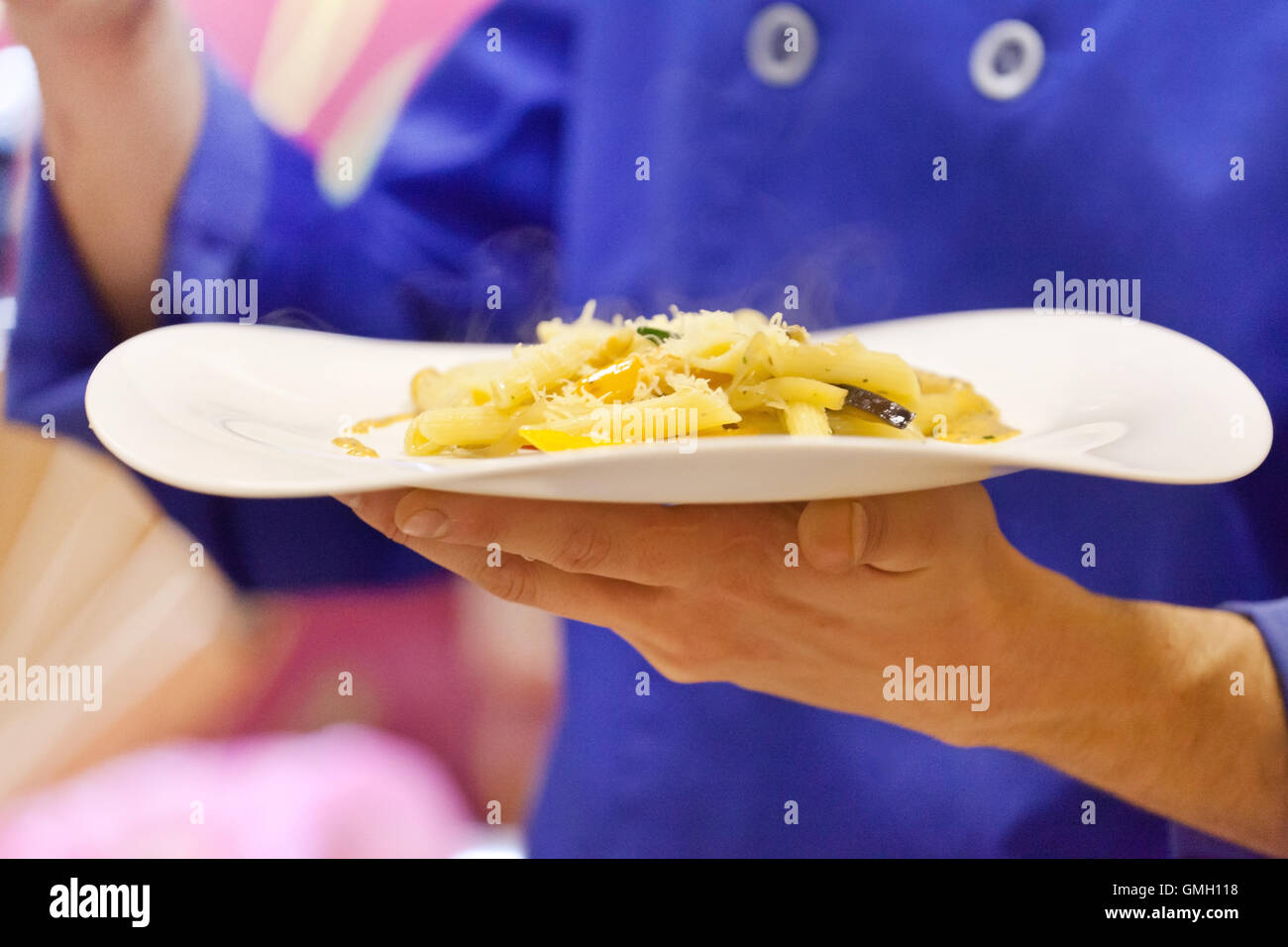 chef with plate of pasta Stock Photo - Alamy